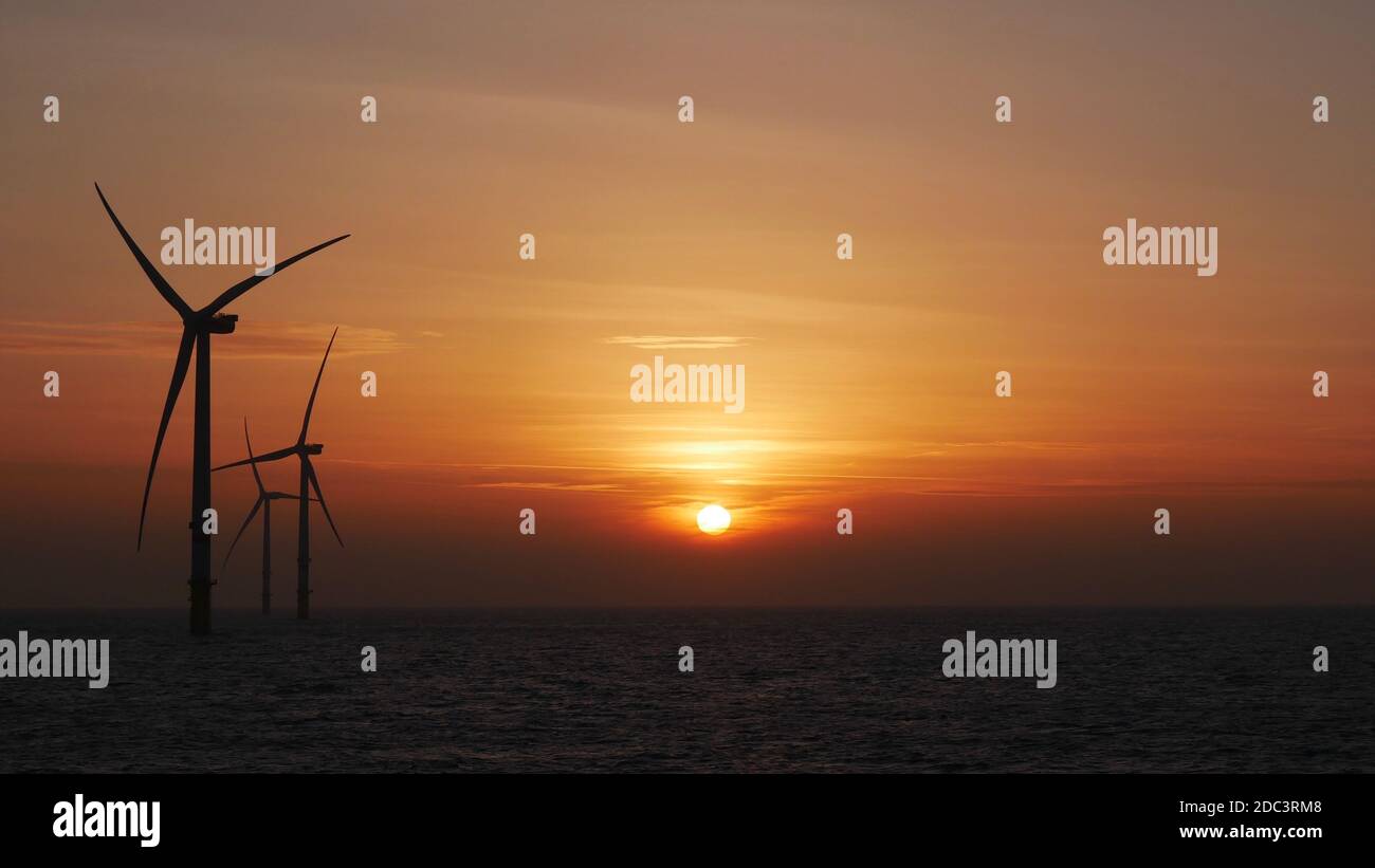 Dramatic sunset in offshore wind farm in north sea during perfect ...