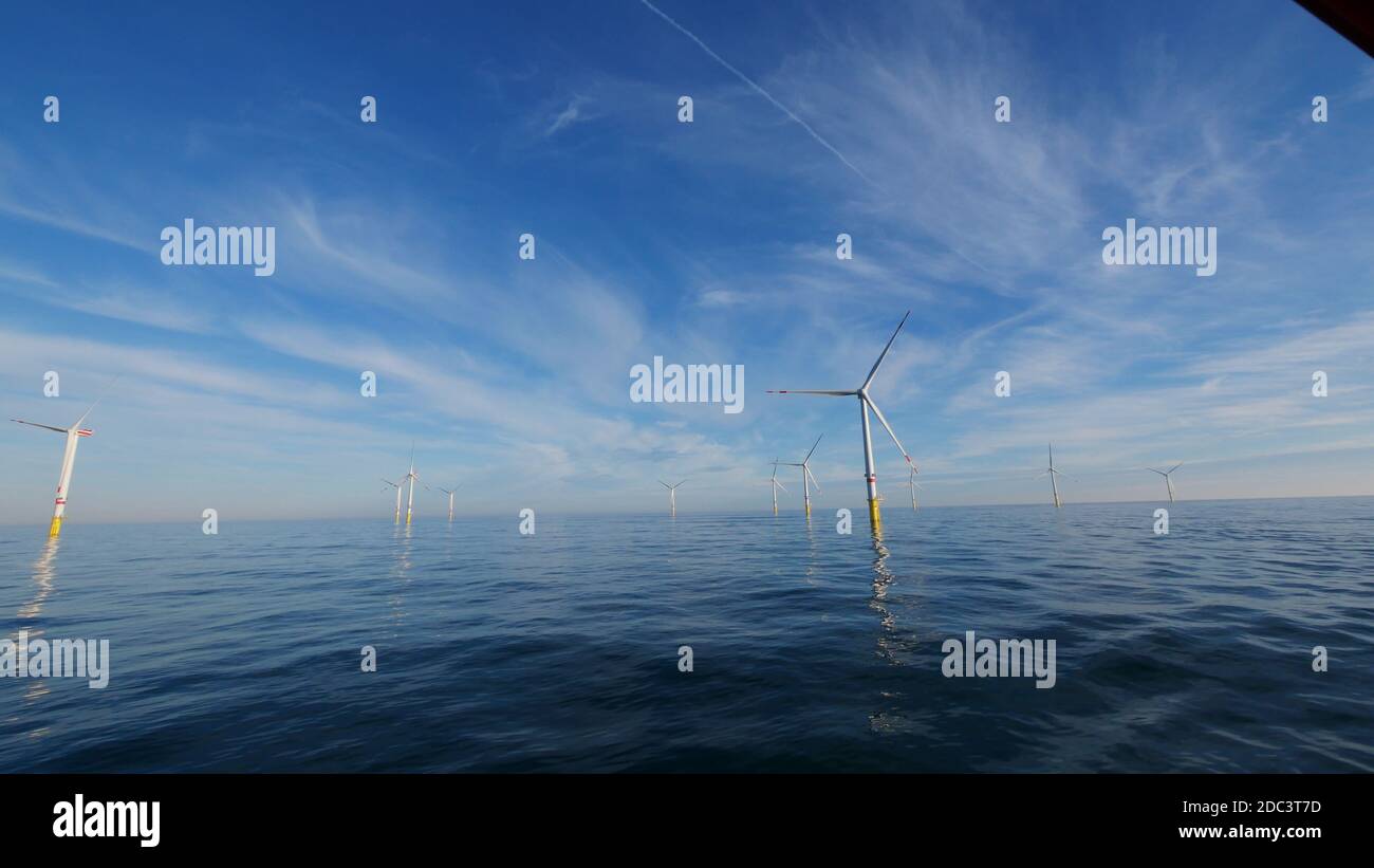 German wind turbines in offshore wind farm in north sea during perfect ...
