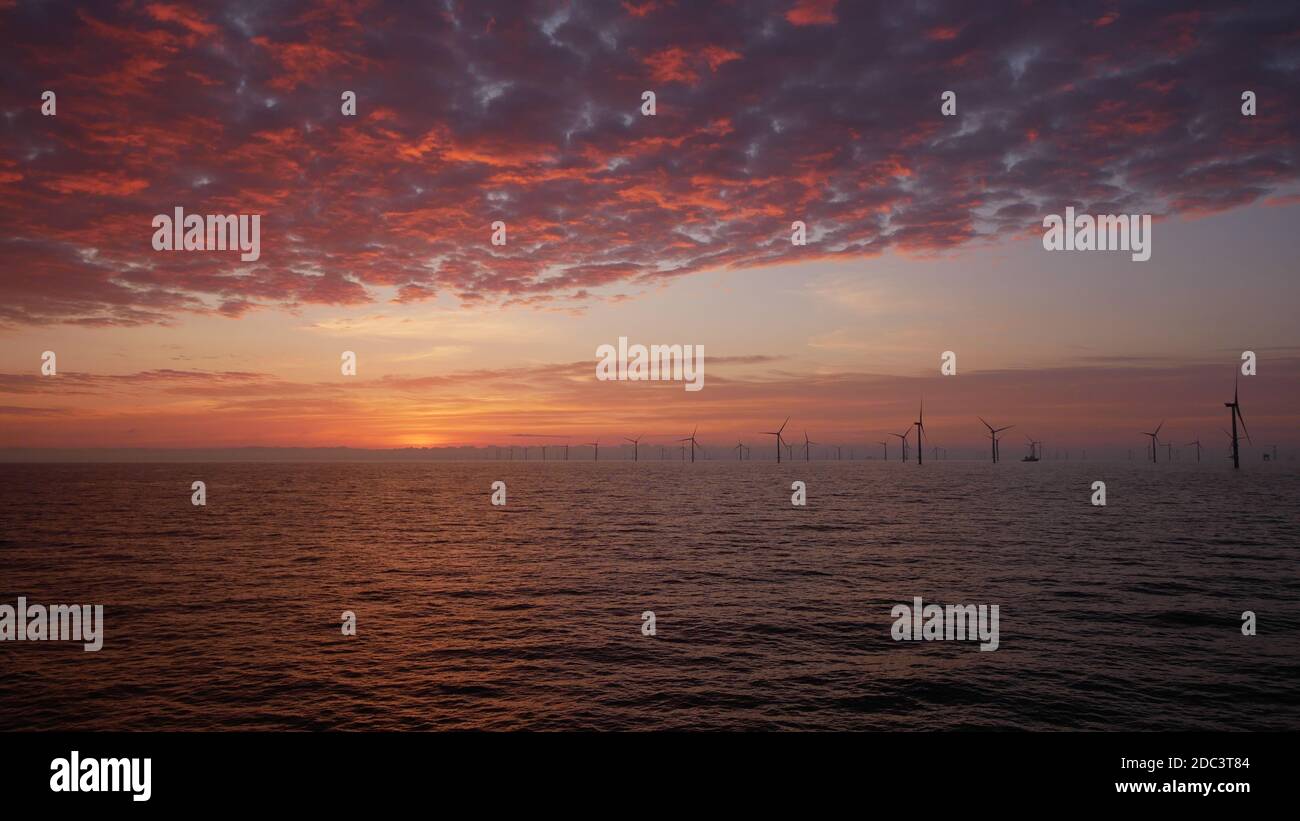 Dramatic sunset in offshore wind farm in north sea during perfect ...