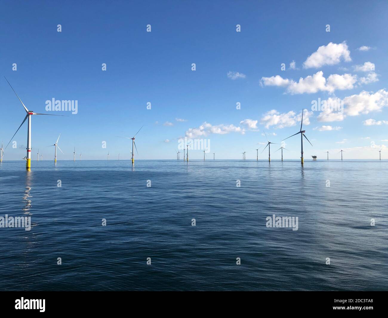 German wind turbines in offshore wind farm in north sea during perfect ...