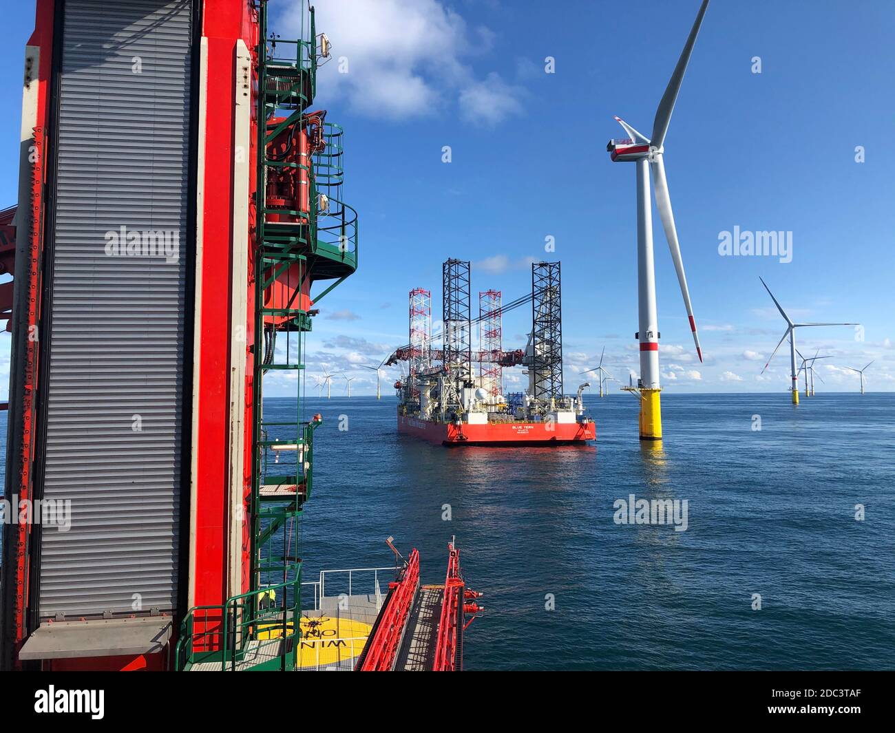 Jack up barge next to wind turbine in offshore wind farm north sea ...