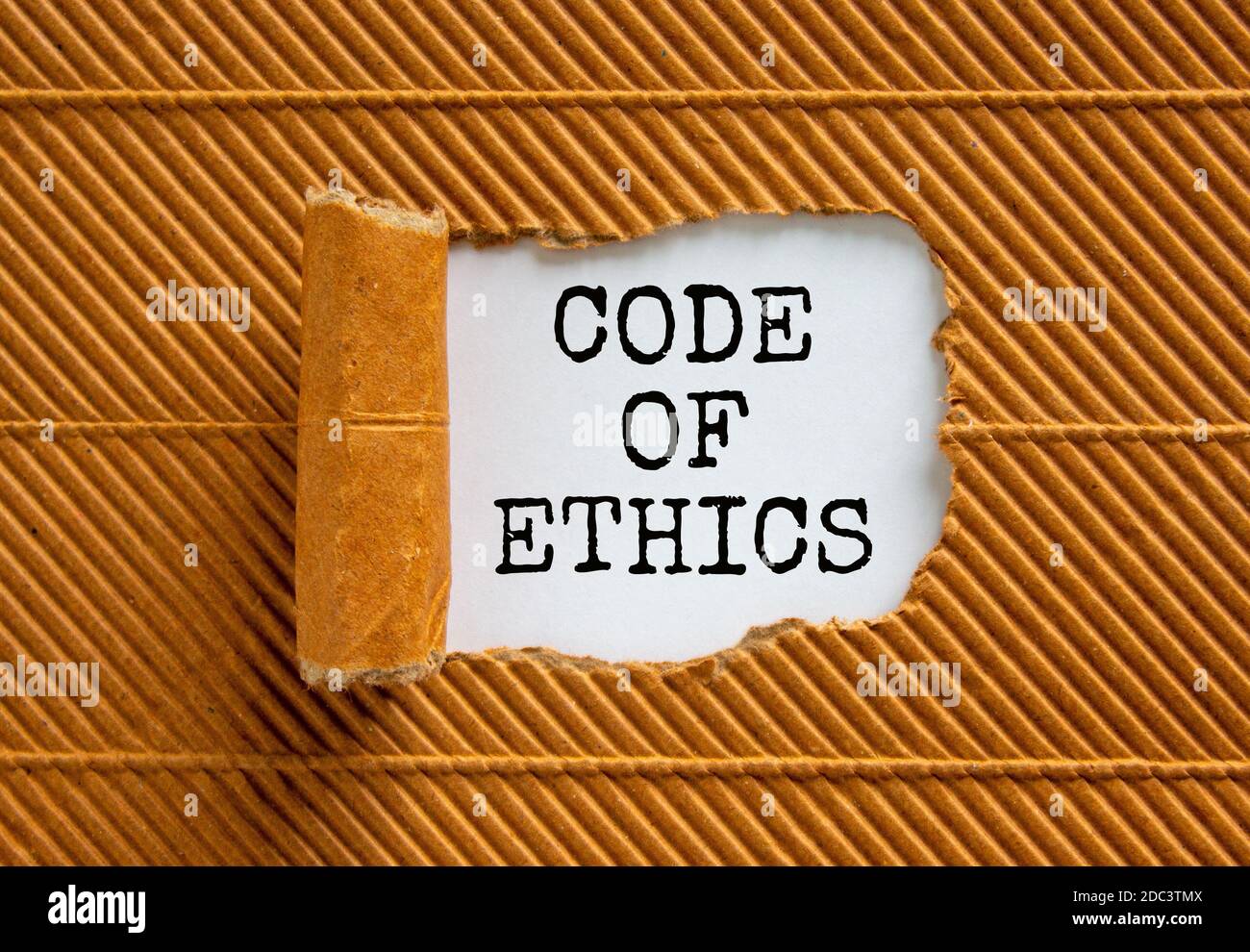 The words 'code of ethics' appearing behind torn brown paper. Beautiful ...