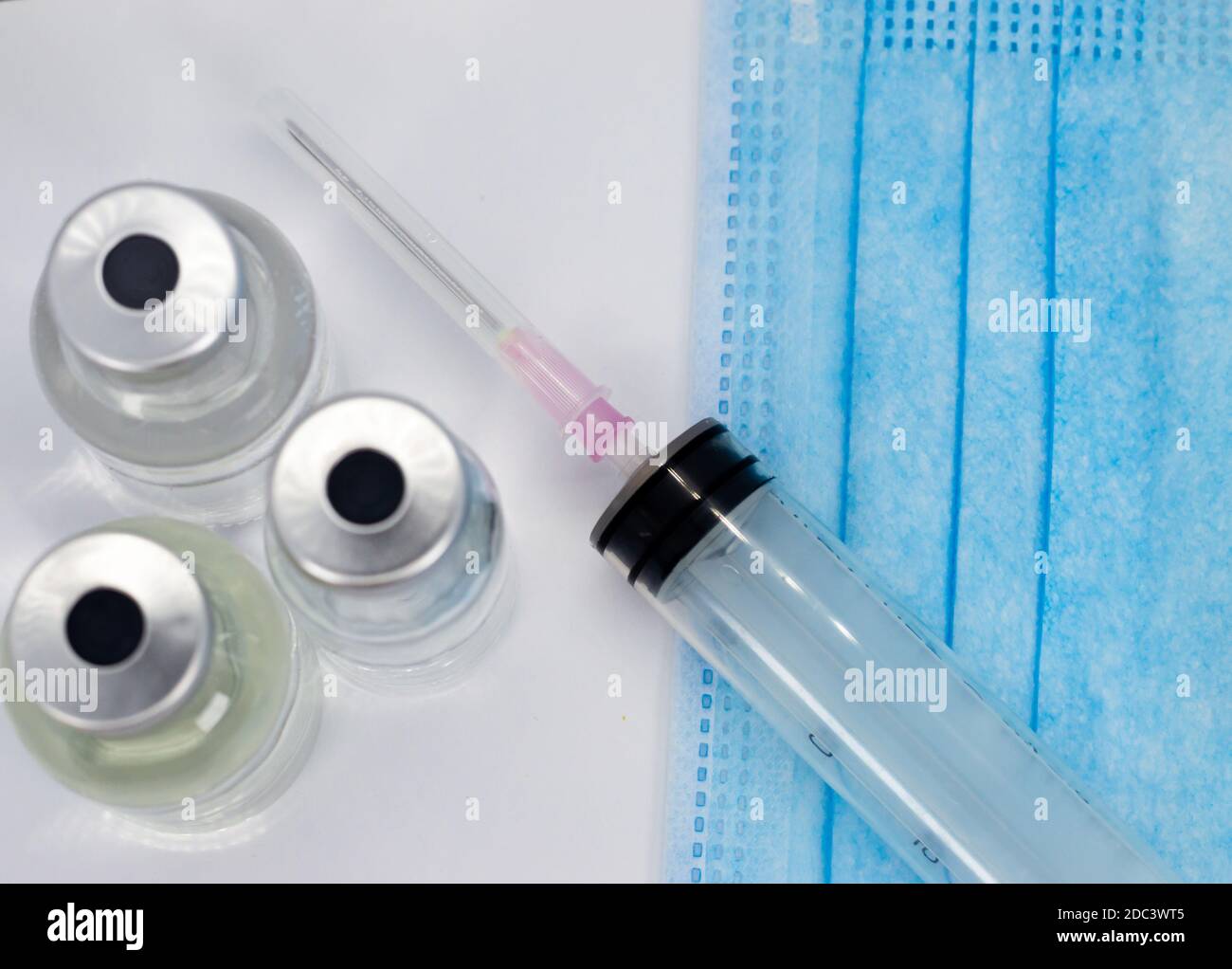 Vaccine Vial, Syringe and blue Medical Face Mask Stock Photo - Alamy