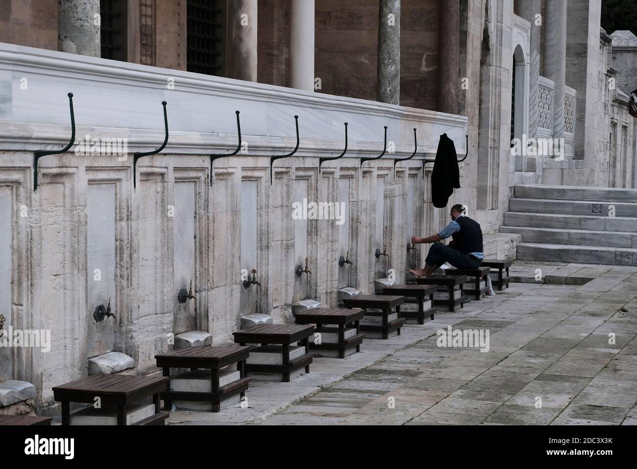 A Muslim man washes his feet before prayer at Suleymaniye Mosque in ...
