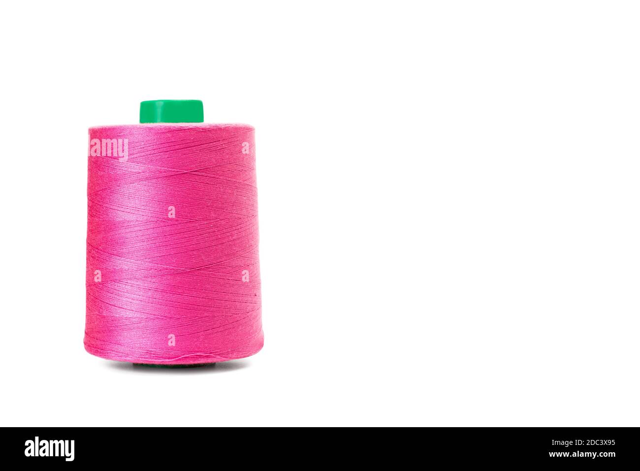 Sewing pink thread spool on a white background with copy space Stock ...