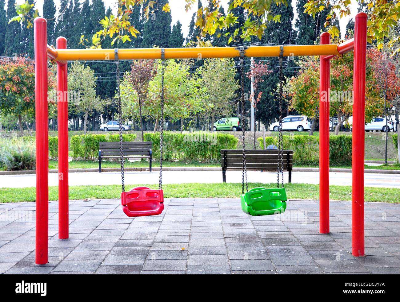 a colourful swing in the park Stock Photo - Alamy