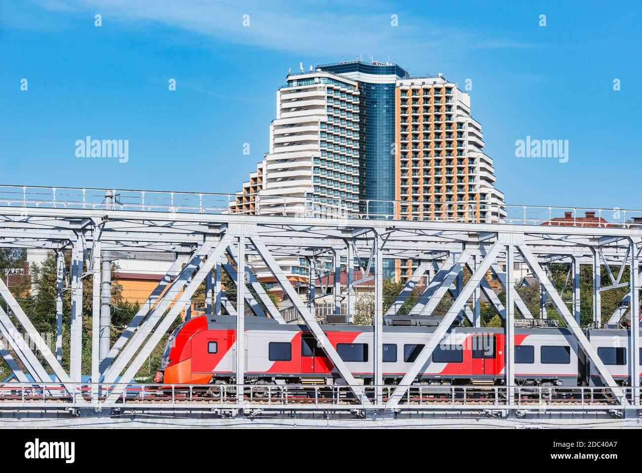 Passenger train moves through the bridge. Sochi.. Russia Stock Photo ...