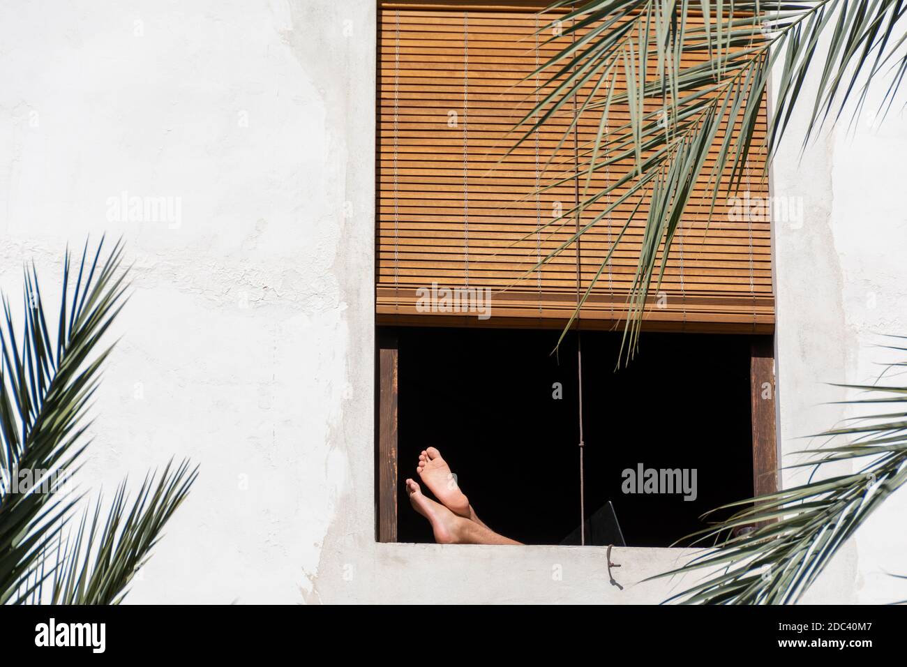 Man peeking out of a window hi-res stock photography and images - Alamy