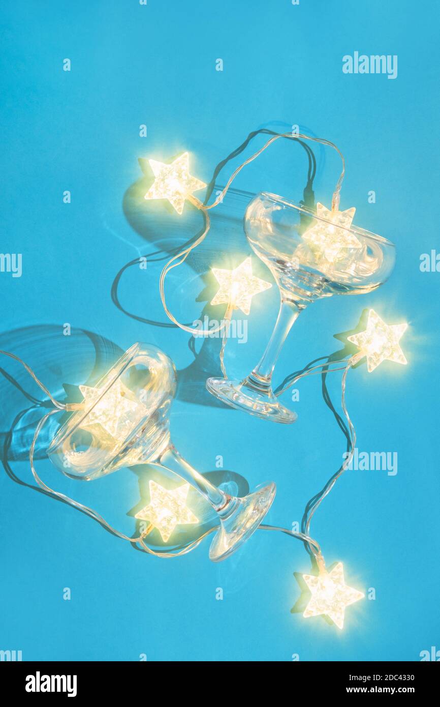 Christmas minimal festive background with star garland in glasses of ...