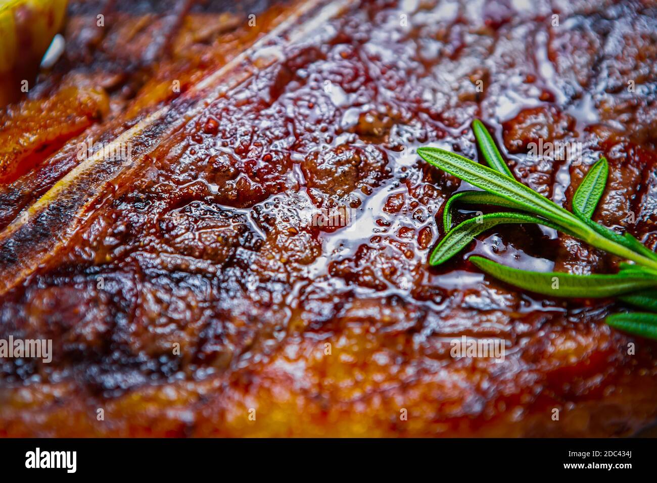 Medium rare t-bone steak cooked on grill in restaurant,served with ...