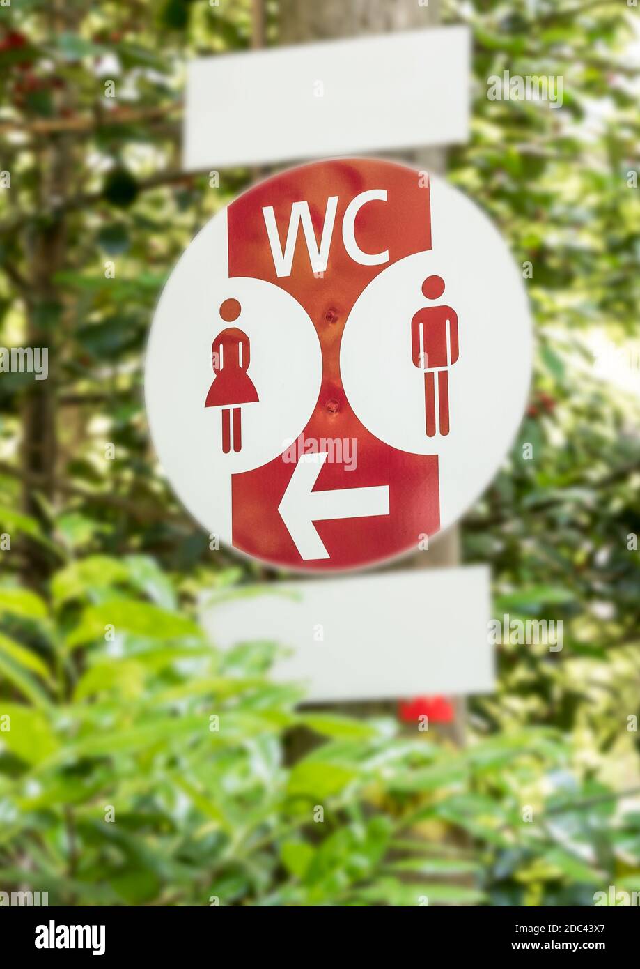Toilet Sign WC for male and female outside in the woods Stock Photo - Alamy