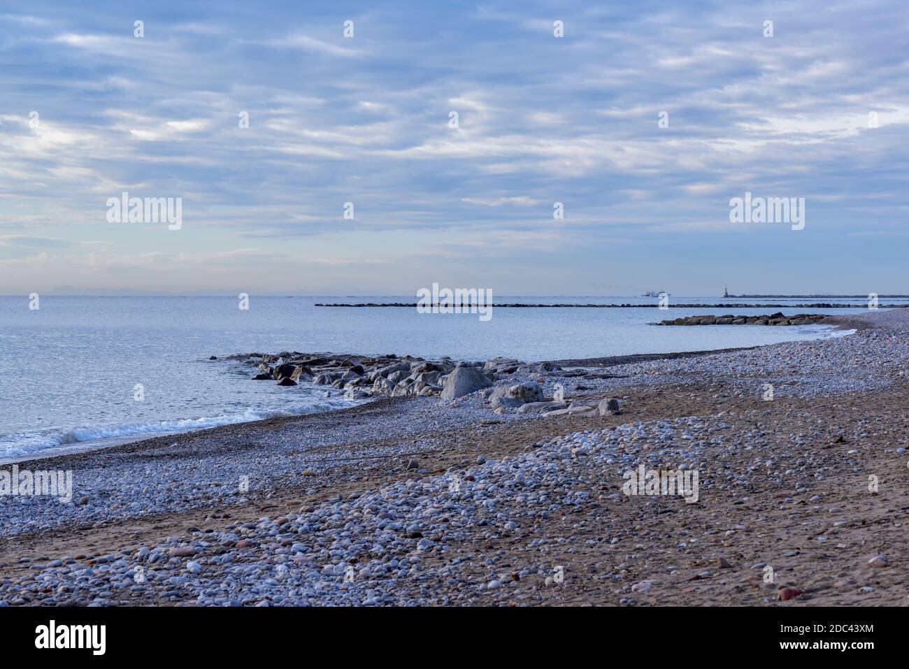 Pebble coastal beach with small rock or stone breakwaters in Burriana ...