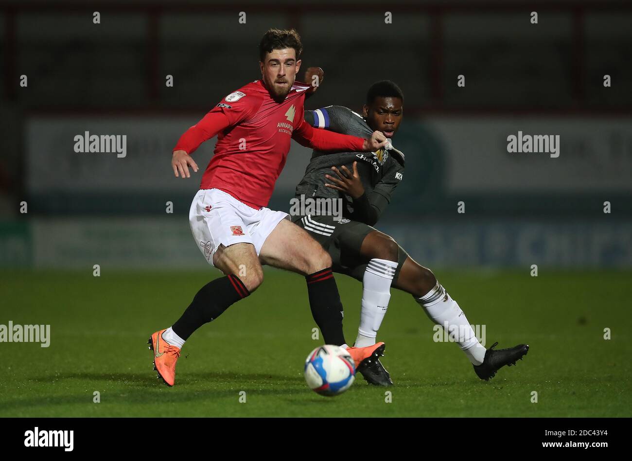 Morecambe's Cole Stockton (left) and Manchester United's Teden Mengi ...