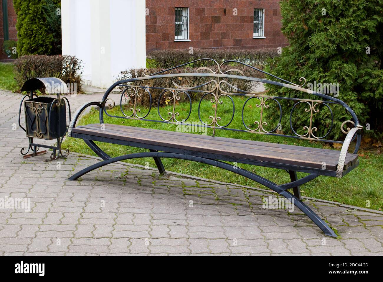 Decorative wrought iron bench and rubbish bin close up Stock Photo - Alamy