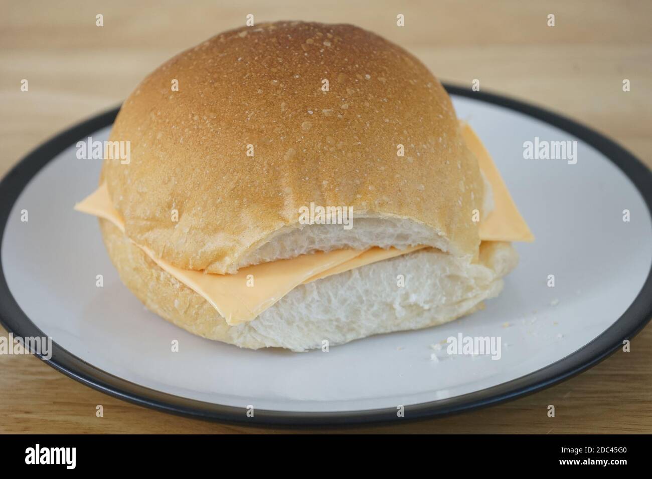 Lonely looking plain cheese roll on a plate Stock Photo - Alamy