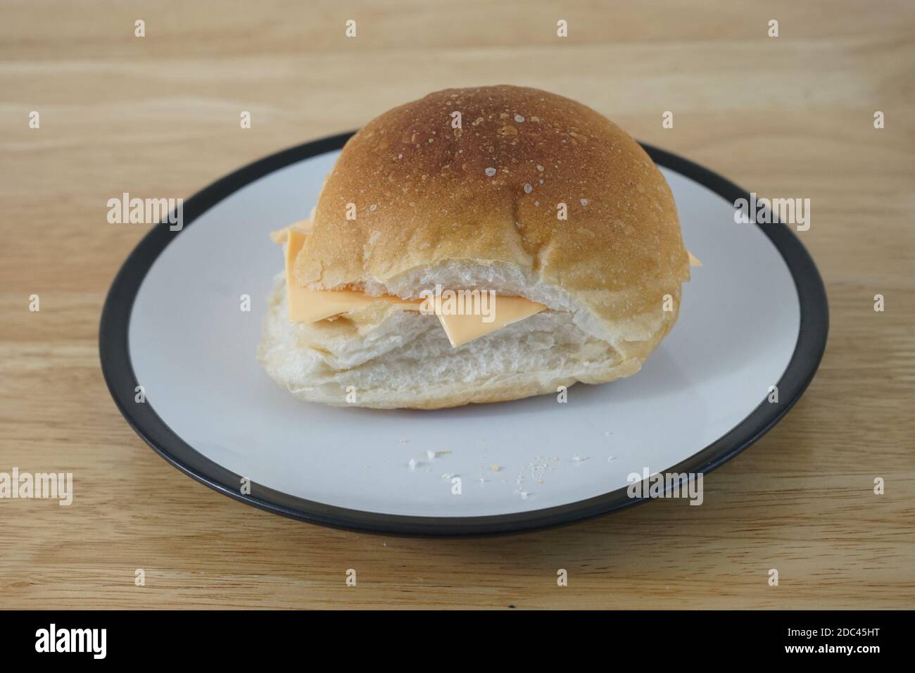 Lonely looking plain cheese roll on a plate Stock Photo - Alamy