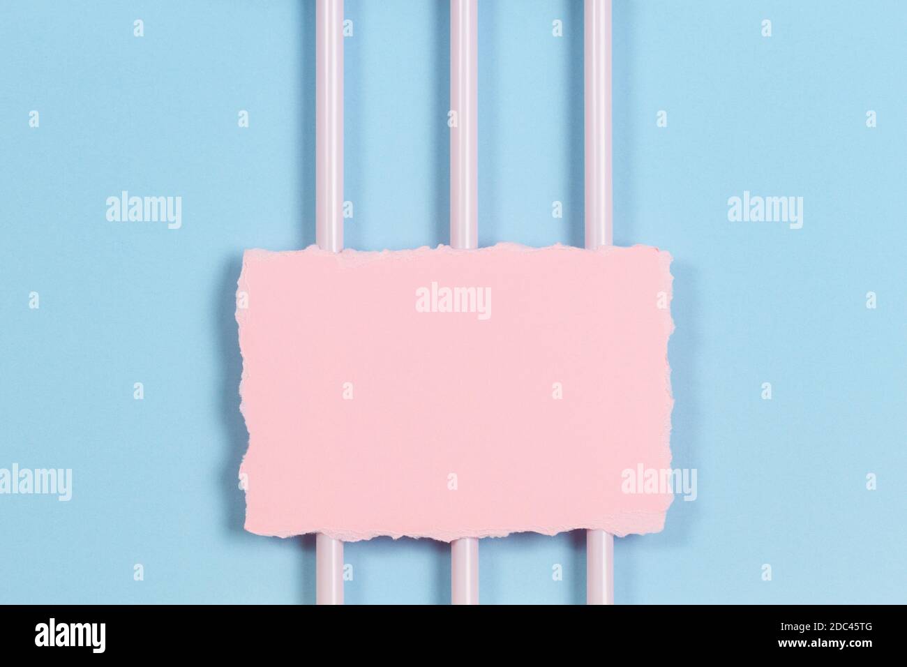 Blank light pink ripped piece of paper, torn paper card on light blue ...