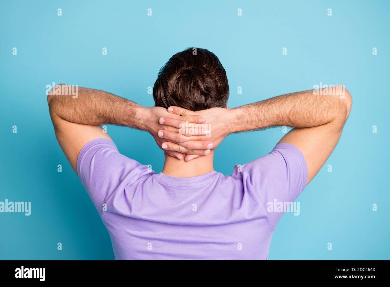 Rear view photo of young handsome man rest relax pause break hands ...