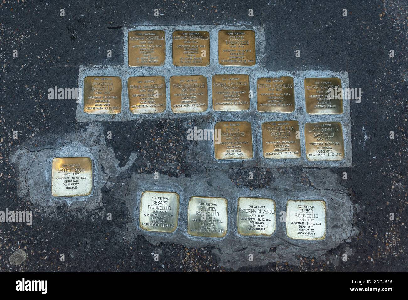 Small square blocks covered with shiny brass placed in front of the ...