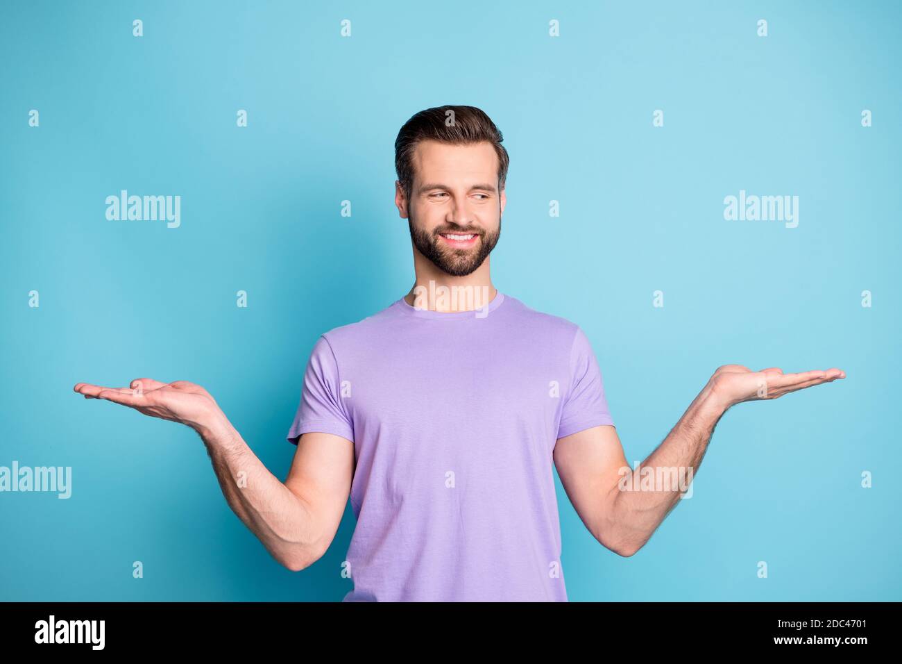 Photo of young handsome guy hold palms balance promo demonstrate ...