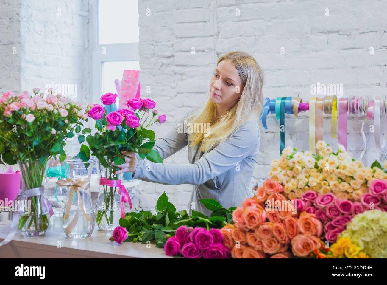Professional floral artist working with flowers at studio Stock Photo ...