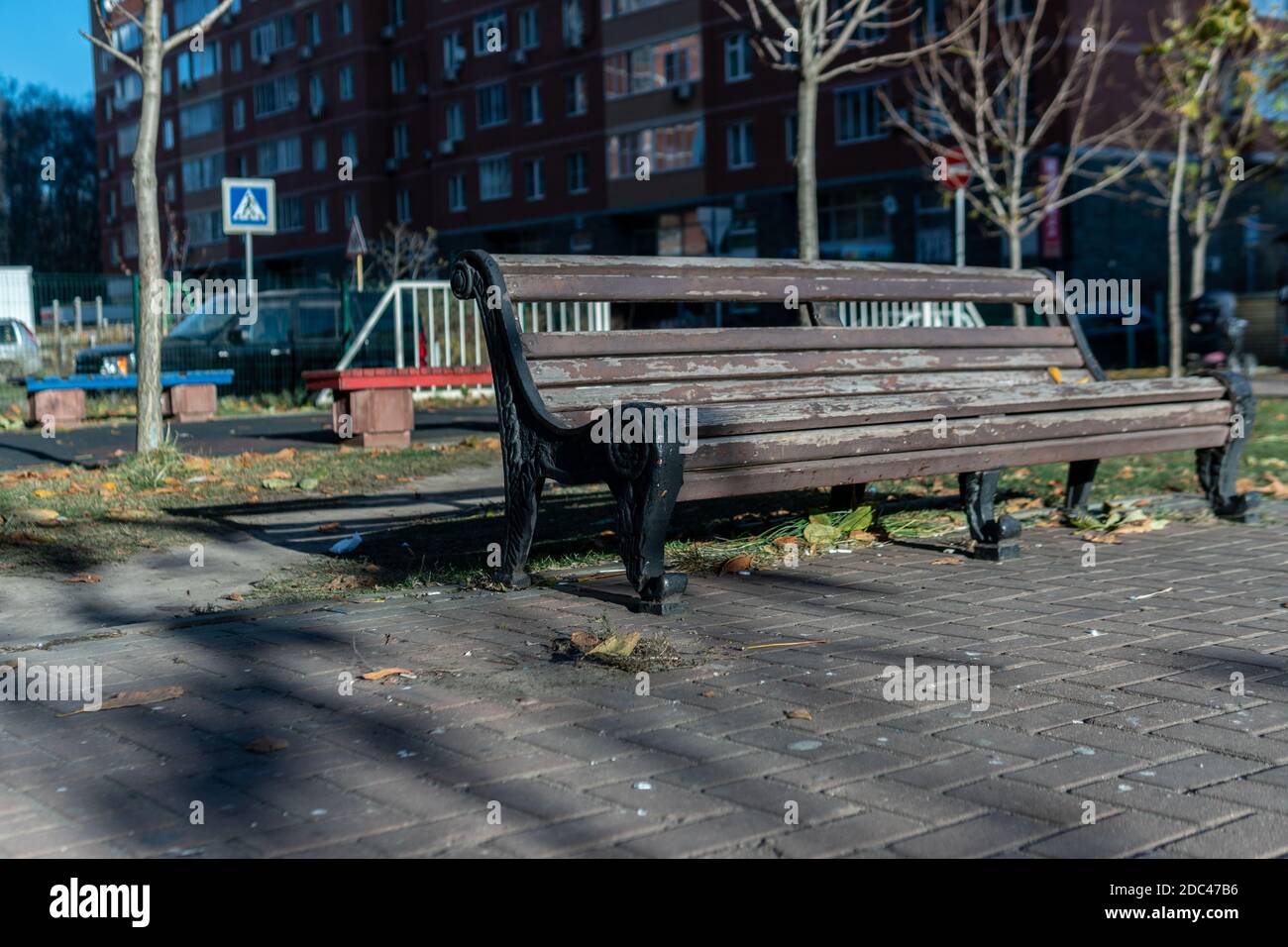 Bench in the park in front of the house sign pedestrian crossing, tile ...