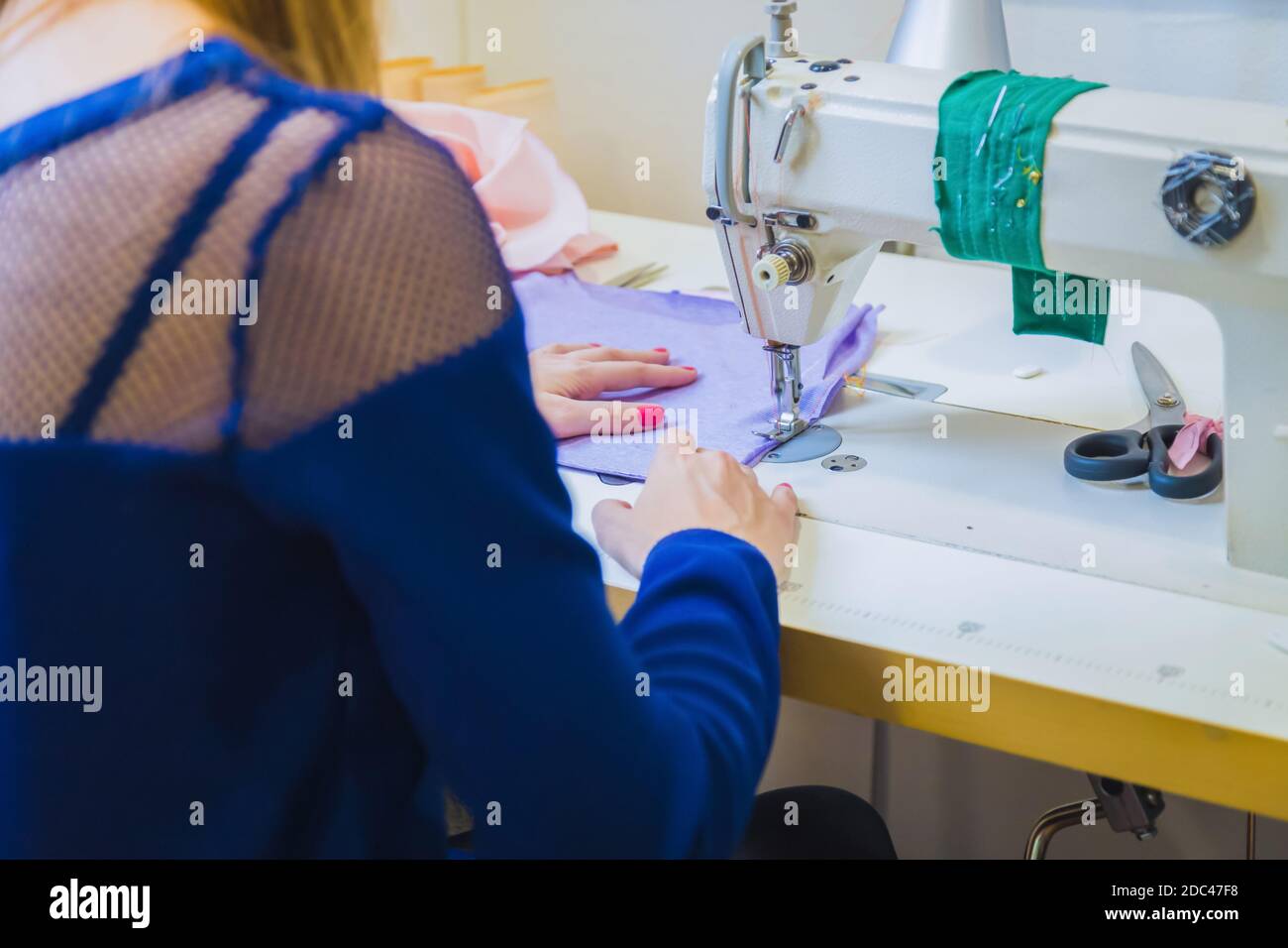 Professional fashion designer using sewing machine at atelier Stock ...