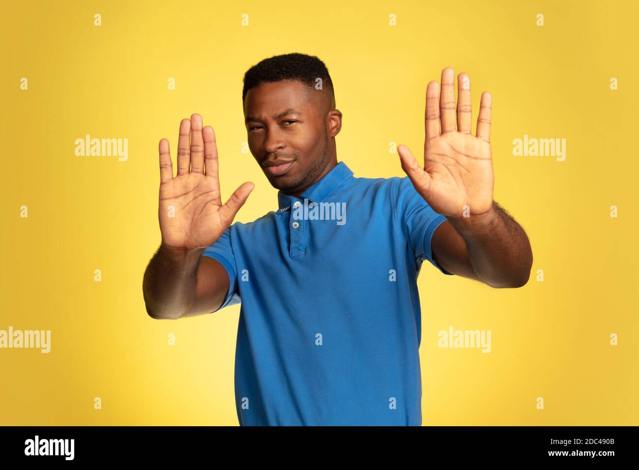 Stopping, rejecting. Young african-american man's portrait isolated on ...