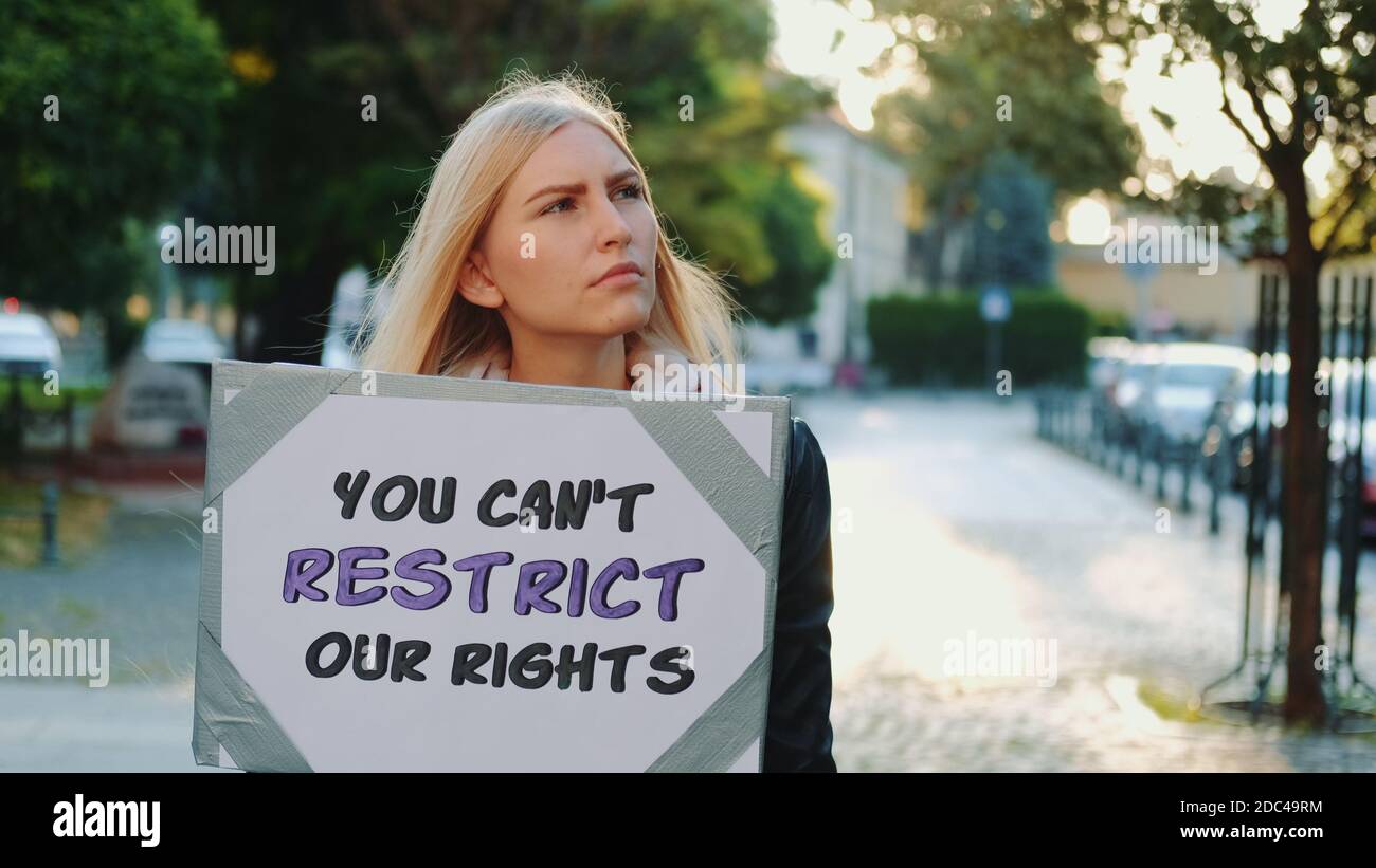 Blonde woman protesting against human rights restriction by walking on ...