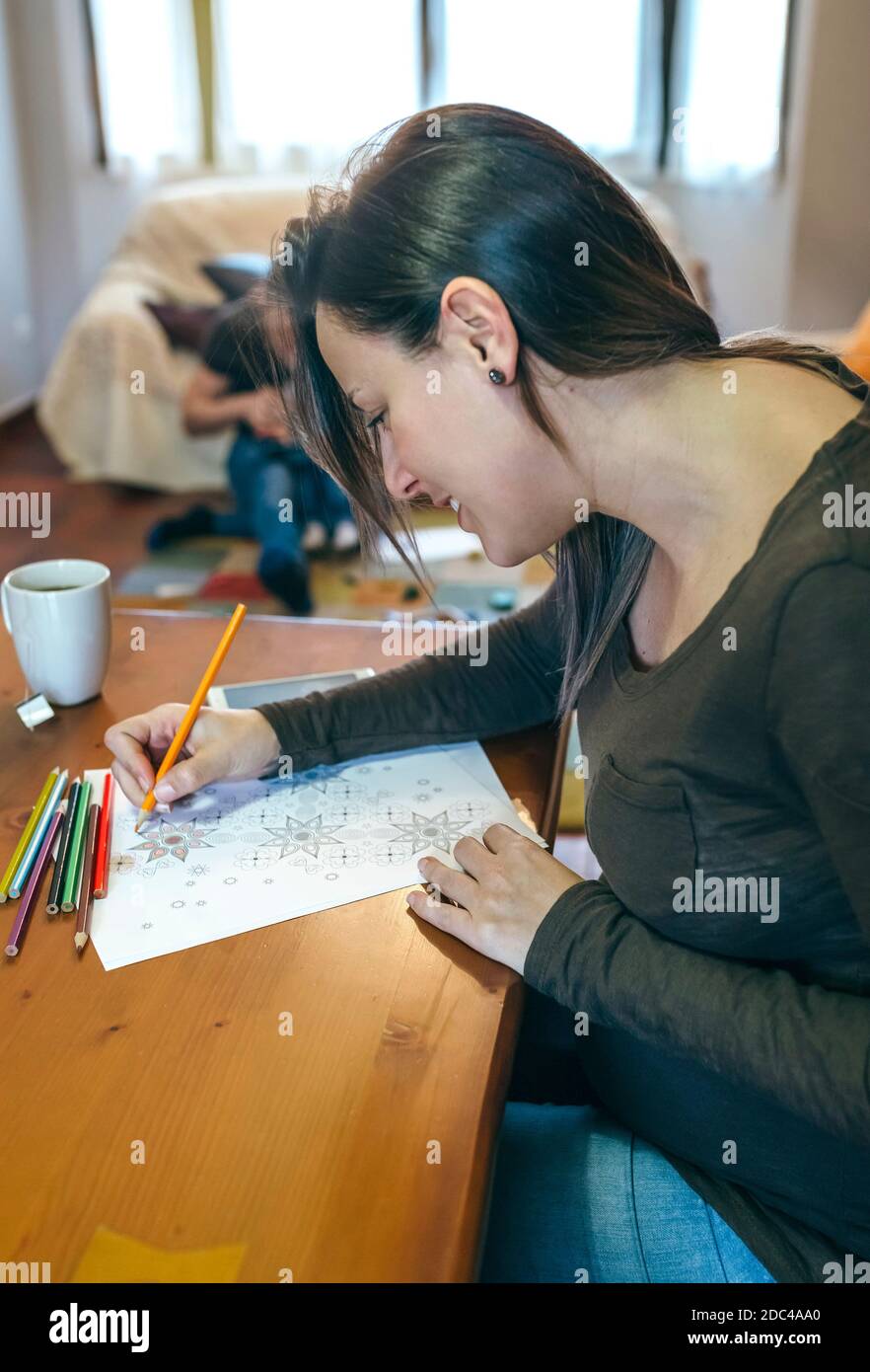 Young woman coloring mandalas Stock Photo - Alamy