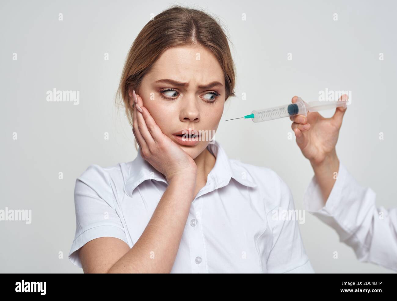 scared woman and syringe with needle near face Stock Photo - Alamy
