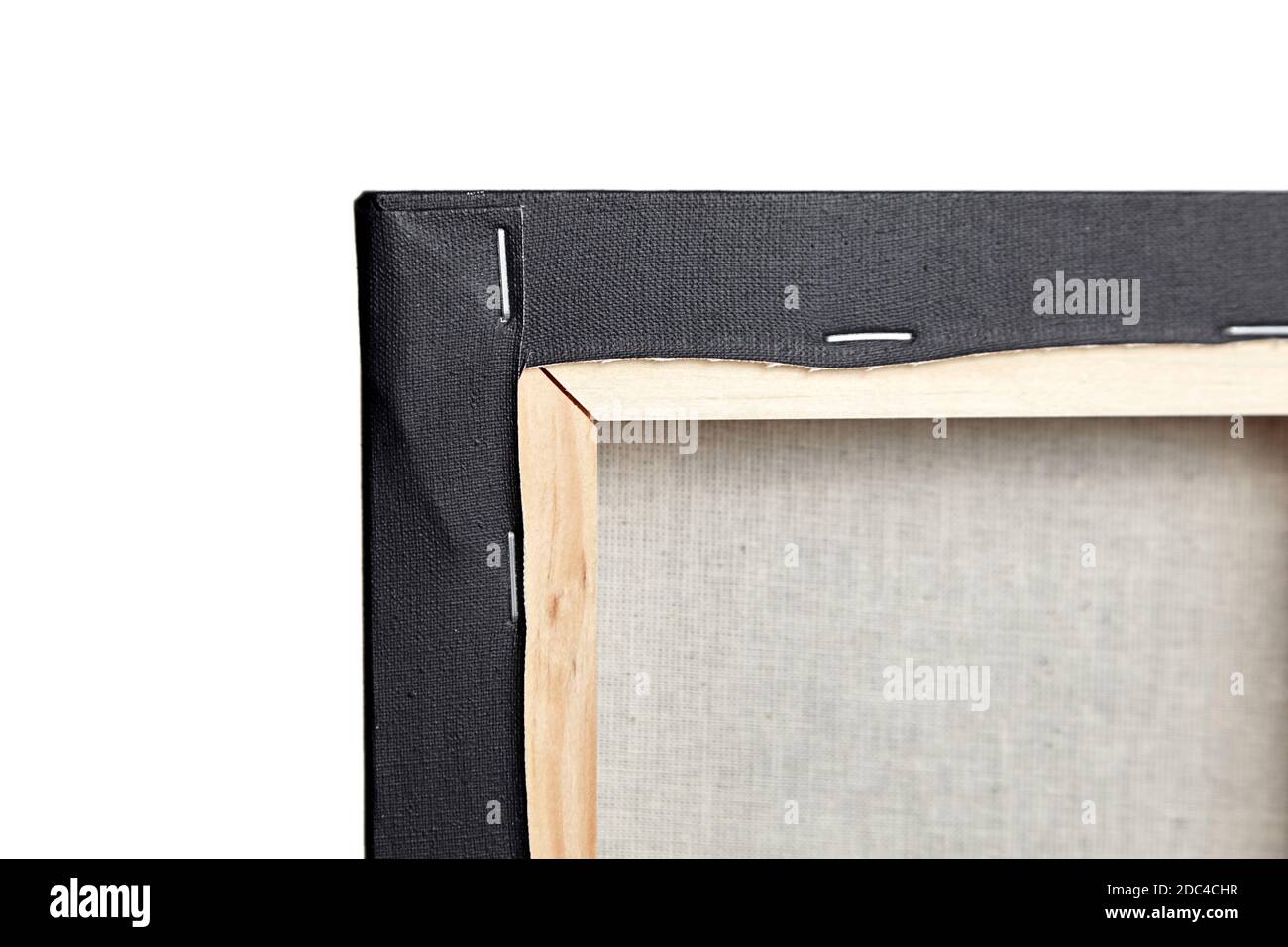 Black cotton canvas stretched on wooden subframe on white background ...