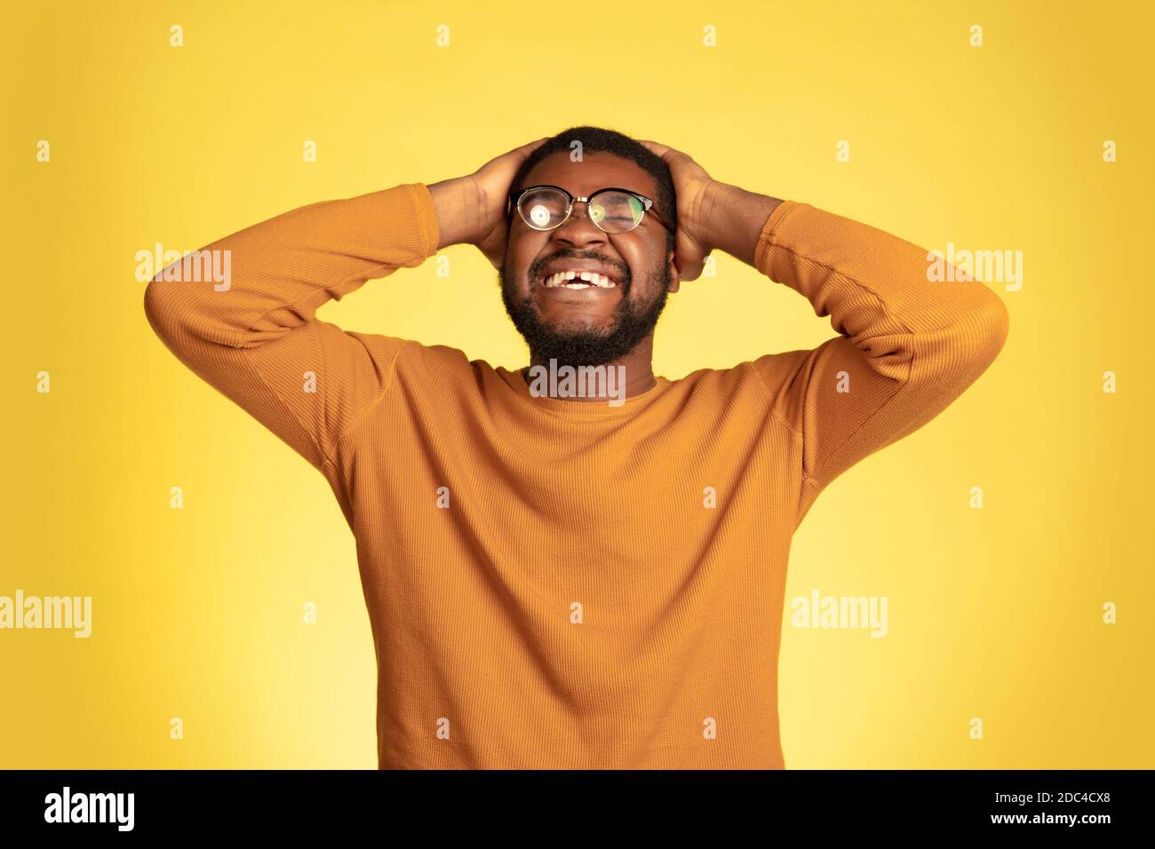 Astonishment. Young african-american man's portrait isolated on yellow ...