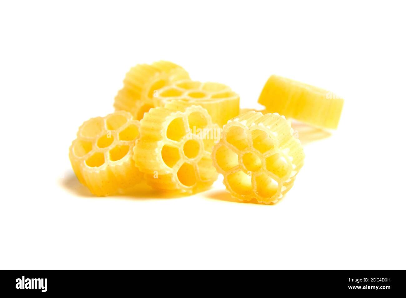 Raw uncooked Rotelle dry italian pasta. Ruote, wagon wheel shaped. Heap ...