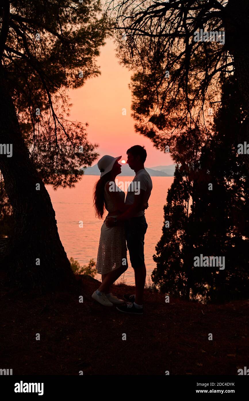 Dark silhouette of a hugging couple in love on the background of the ...