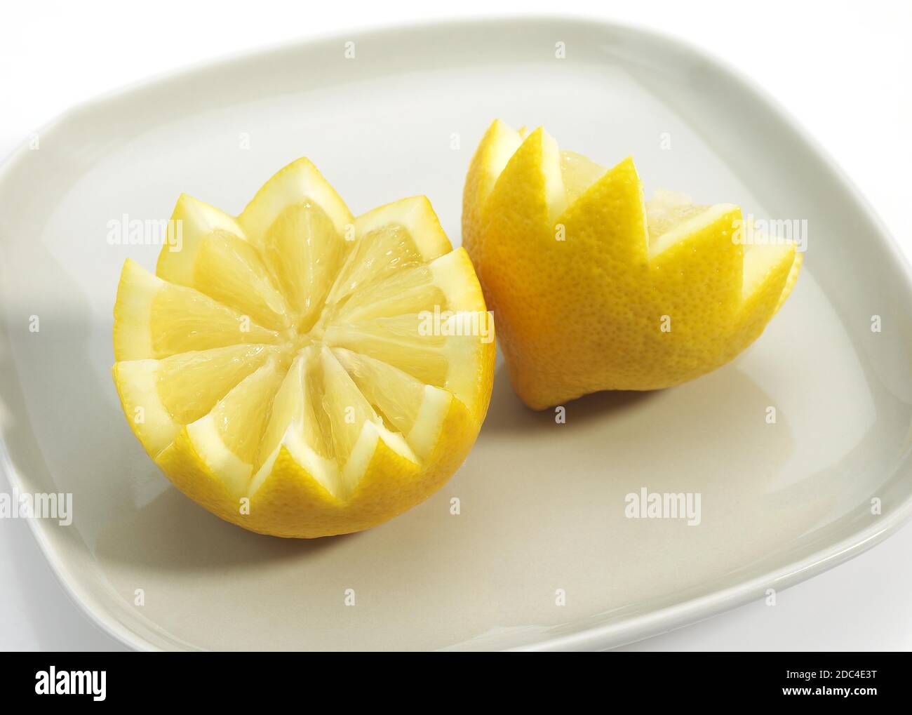 YELLOW LEMON citrus aurantifolia ON PLATE Stock Photo - Alamy