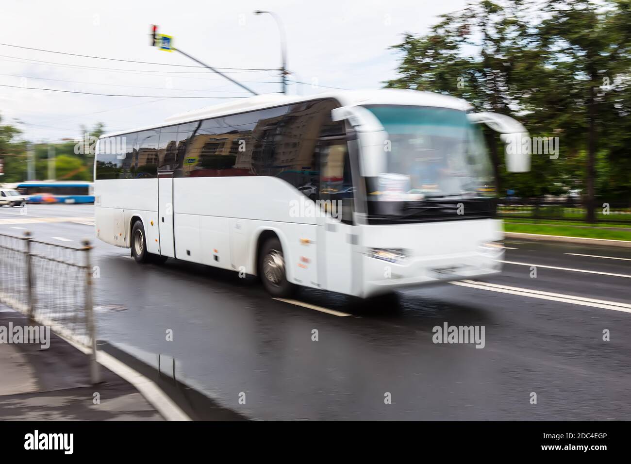 tourist bus is moving along the city street. Blurring Stock Photo - Alamy