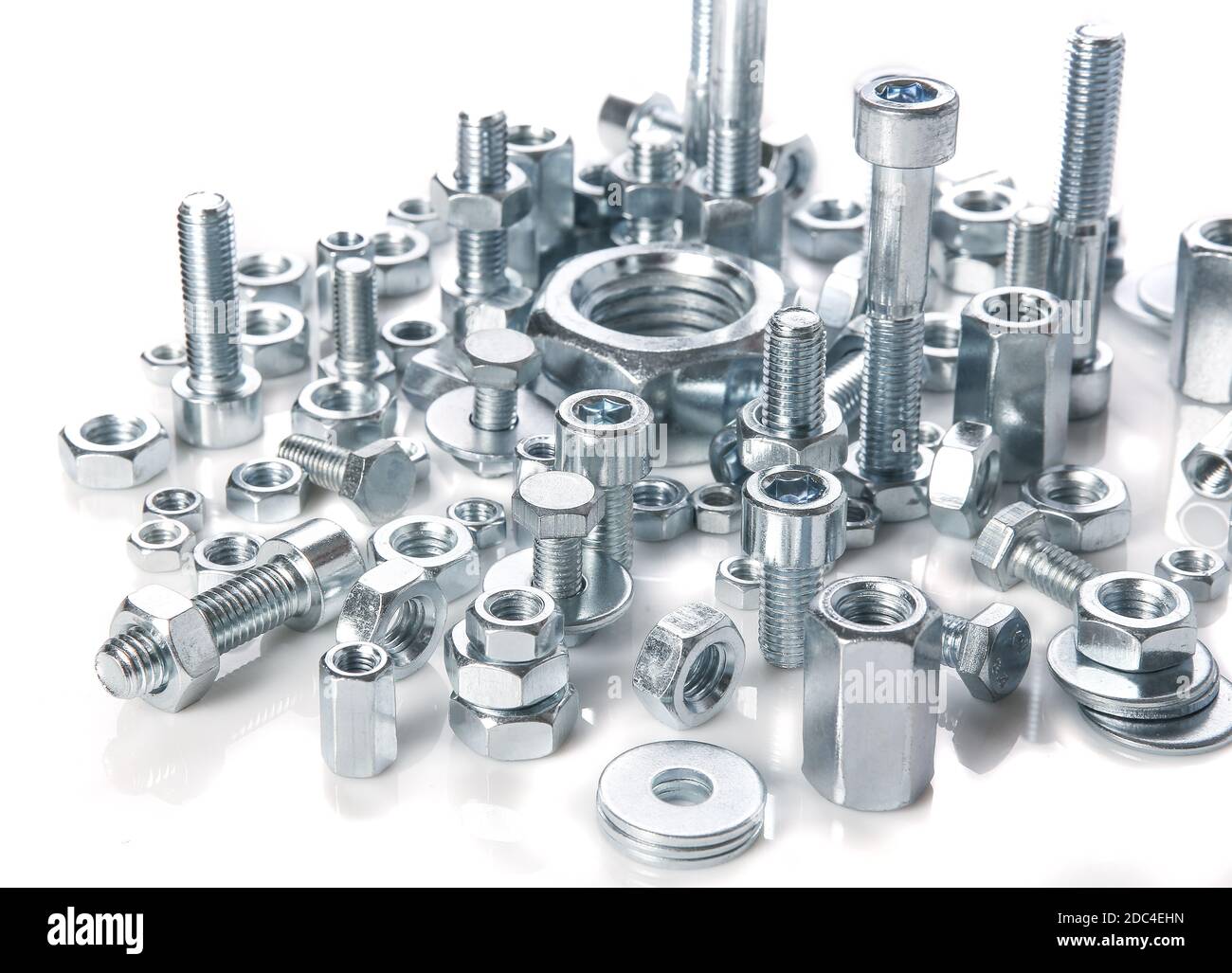 chromeplated bolts and nuts on white background Stock Photo - Alamy
