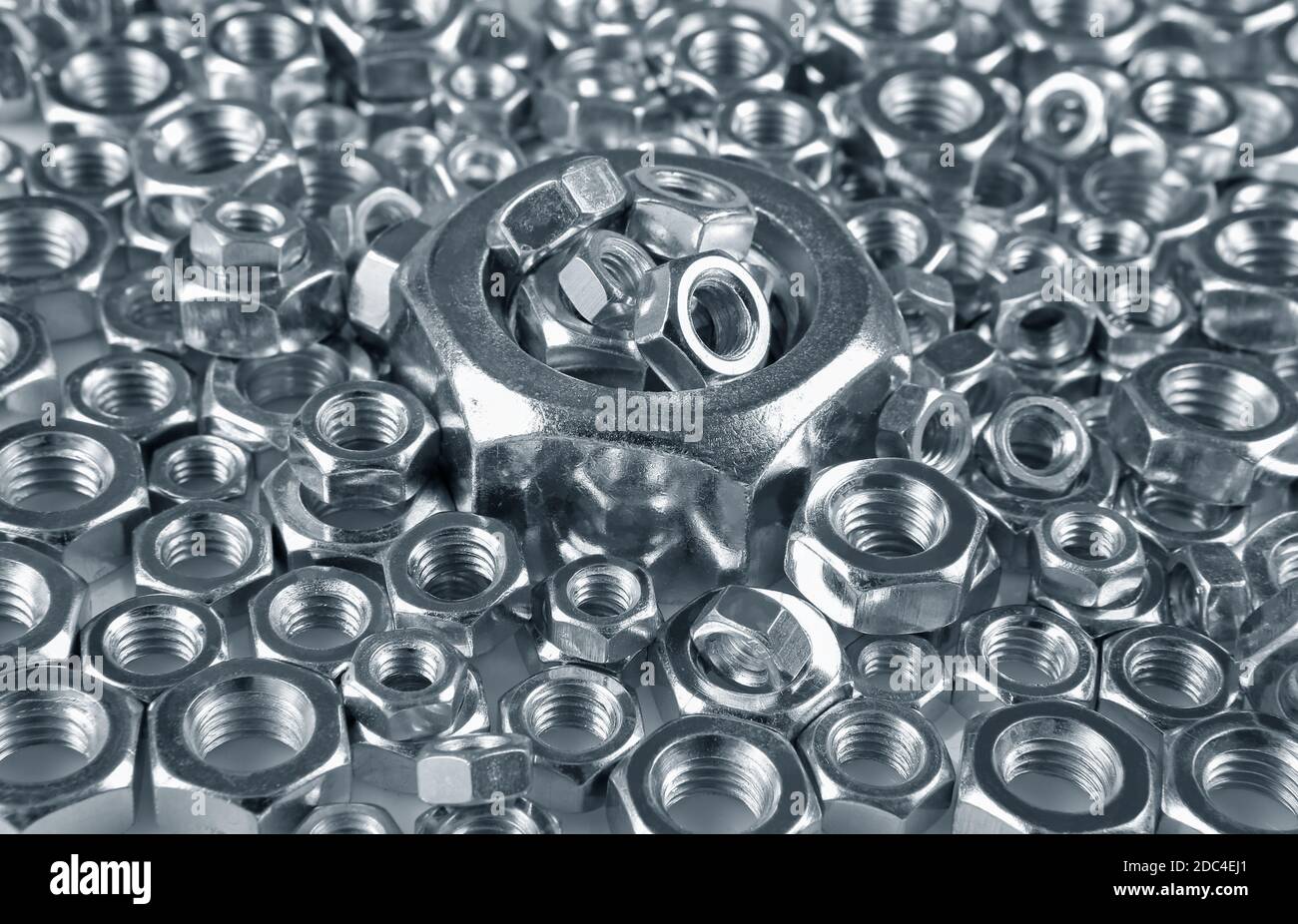 metal shine nuts on white background Stock Photo - Alamy