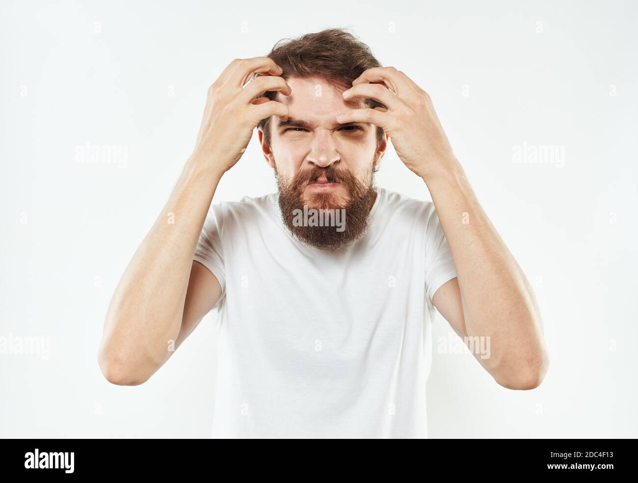 A man with a thick beard gestures irritably with his hands stress ...