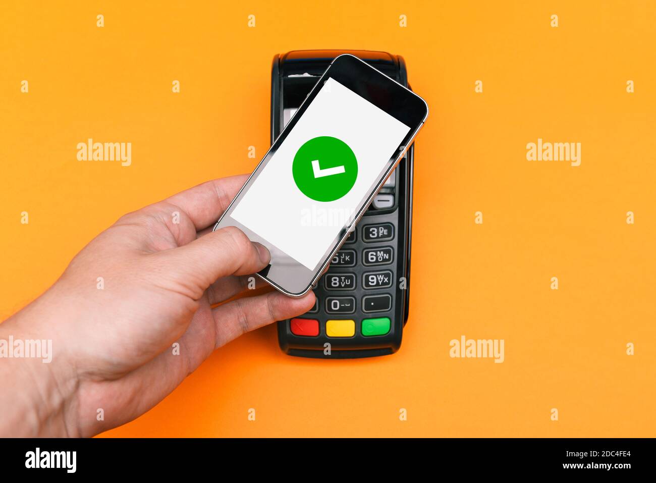 Electronic payment Pos terminal. The client holds the phone for payment ...