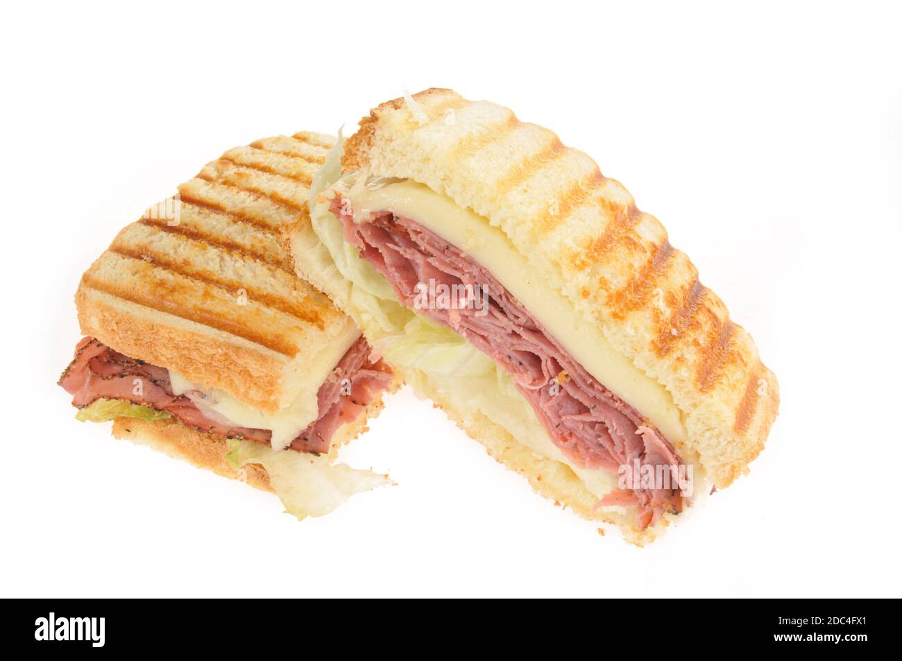 A grilled roast beef panini with swiss cheese on a white background ...