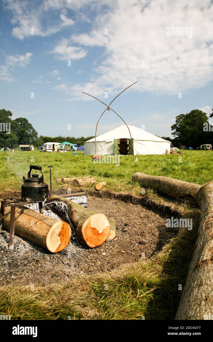 Wiccan campsite with log fire during Pagan festival, Cotswolds, England ...