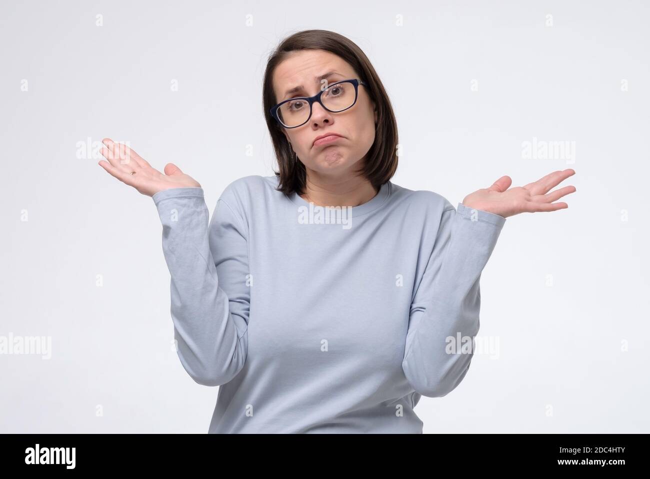 mature woman with clueless and confused expression with arms and hands ...