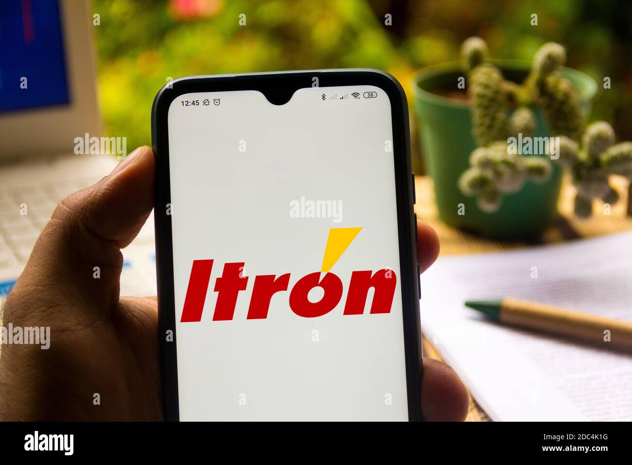 In this photo illustration the Itron logo seen displayed on a ...