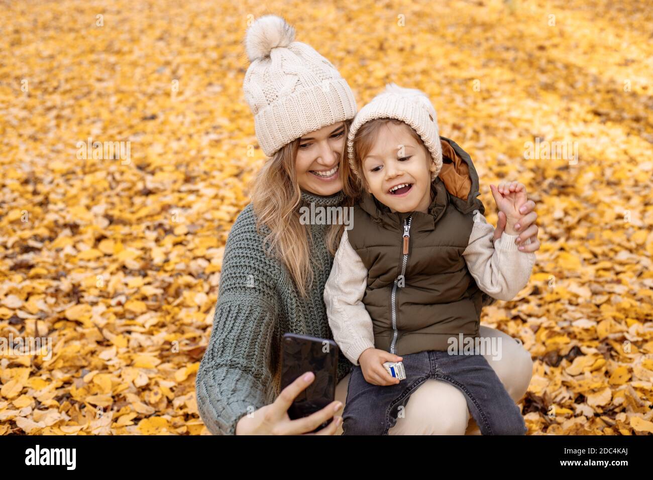 Happy mother and son record video call on smartphone,, laugh, smile ...