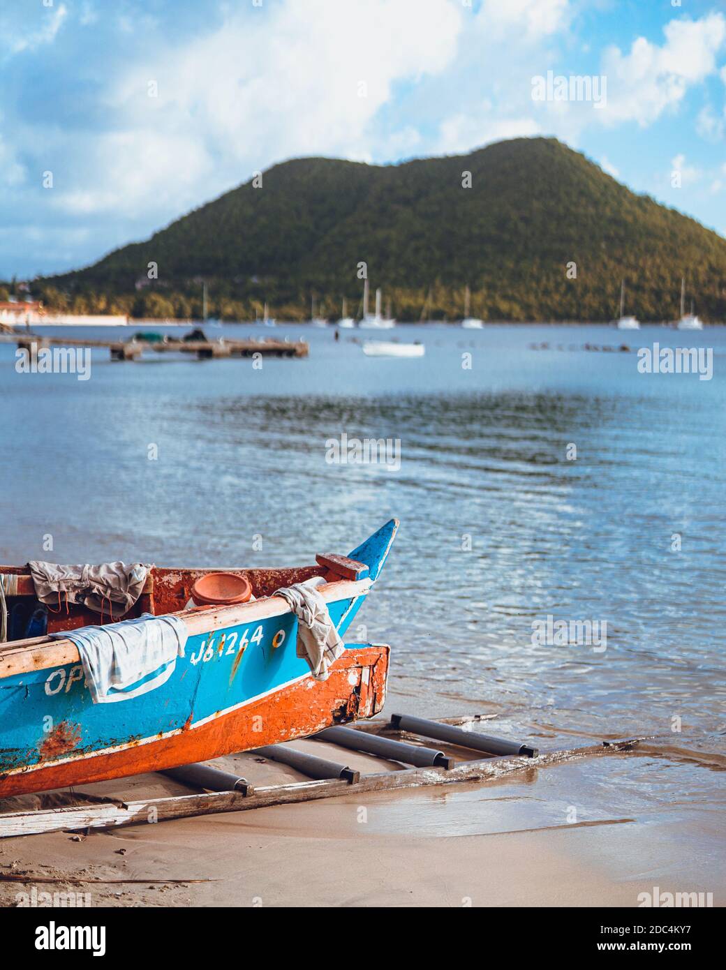 Boat launching into Caribbean waters in front of mountains Stock Photo ...