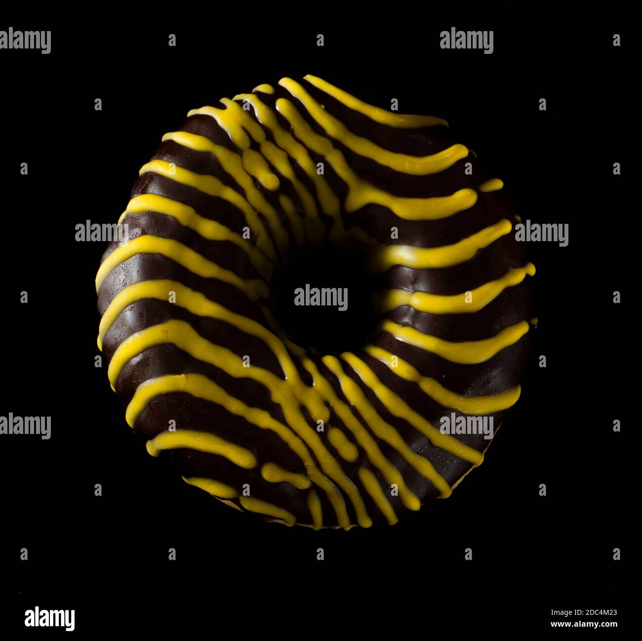 American donut covered with chocolate on black background Stock Photo ...