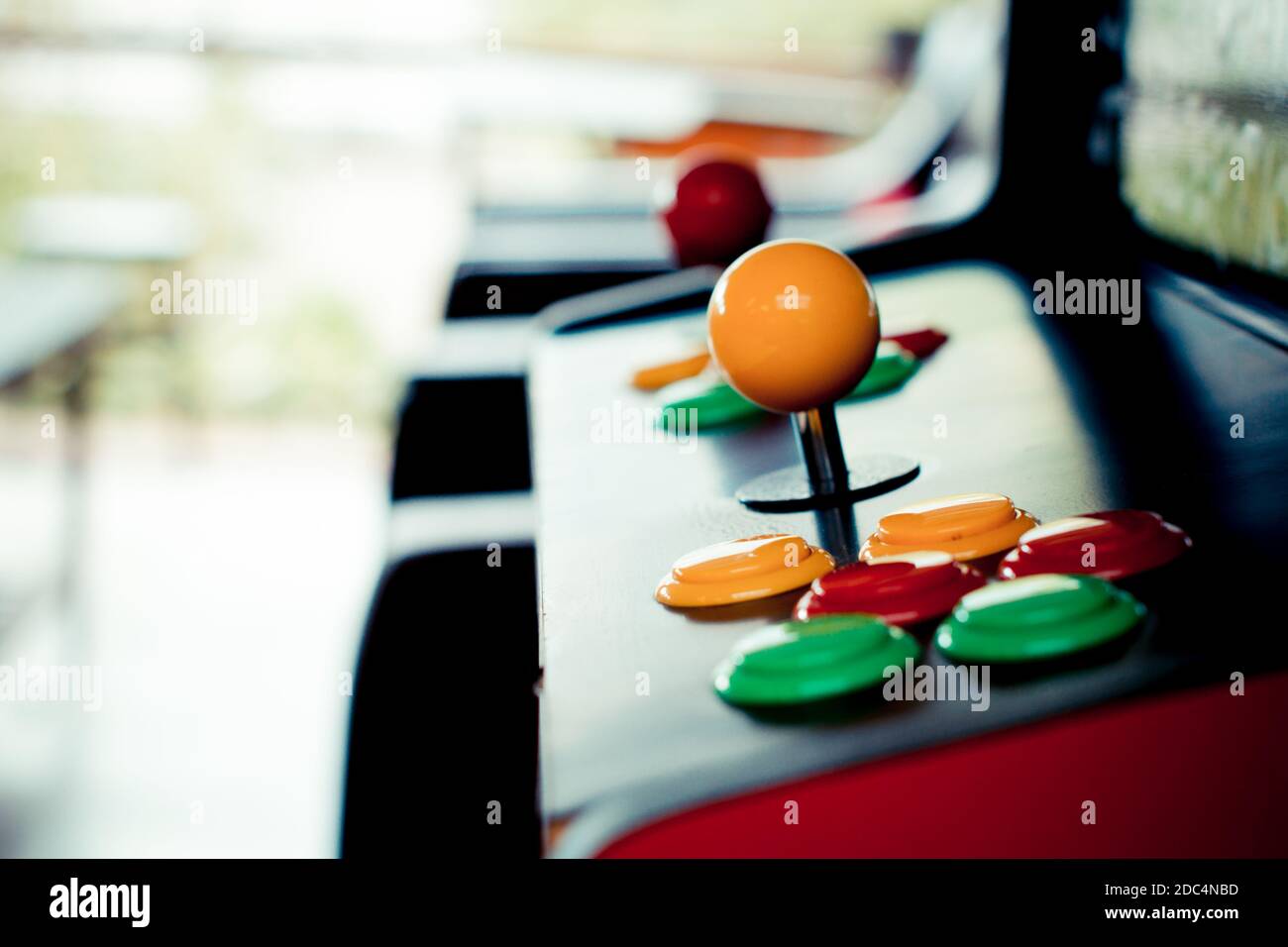 silhouette yellow joystick and six colorful button of an old arcade ...