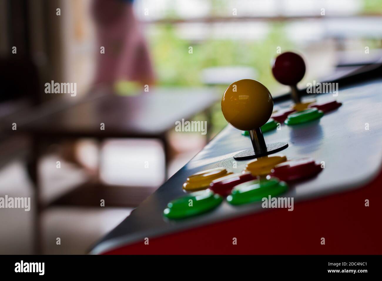 Silhouette Yellow Joystick And Six Colorful Button Of An Old Arcade